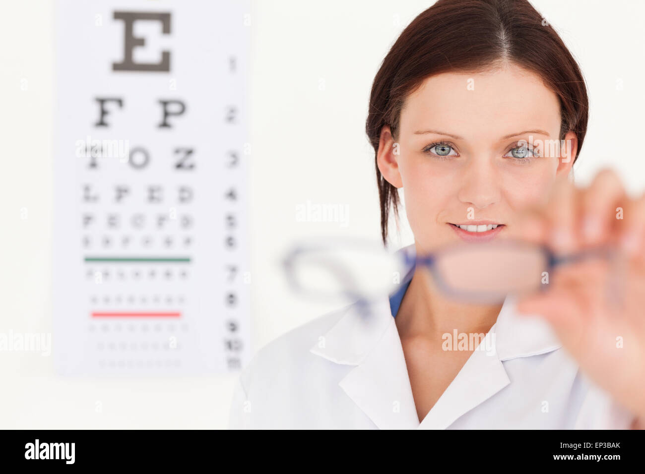 Female optician showing glasses Stock Photo - Alamy