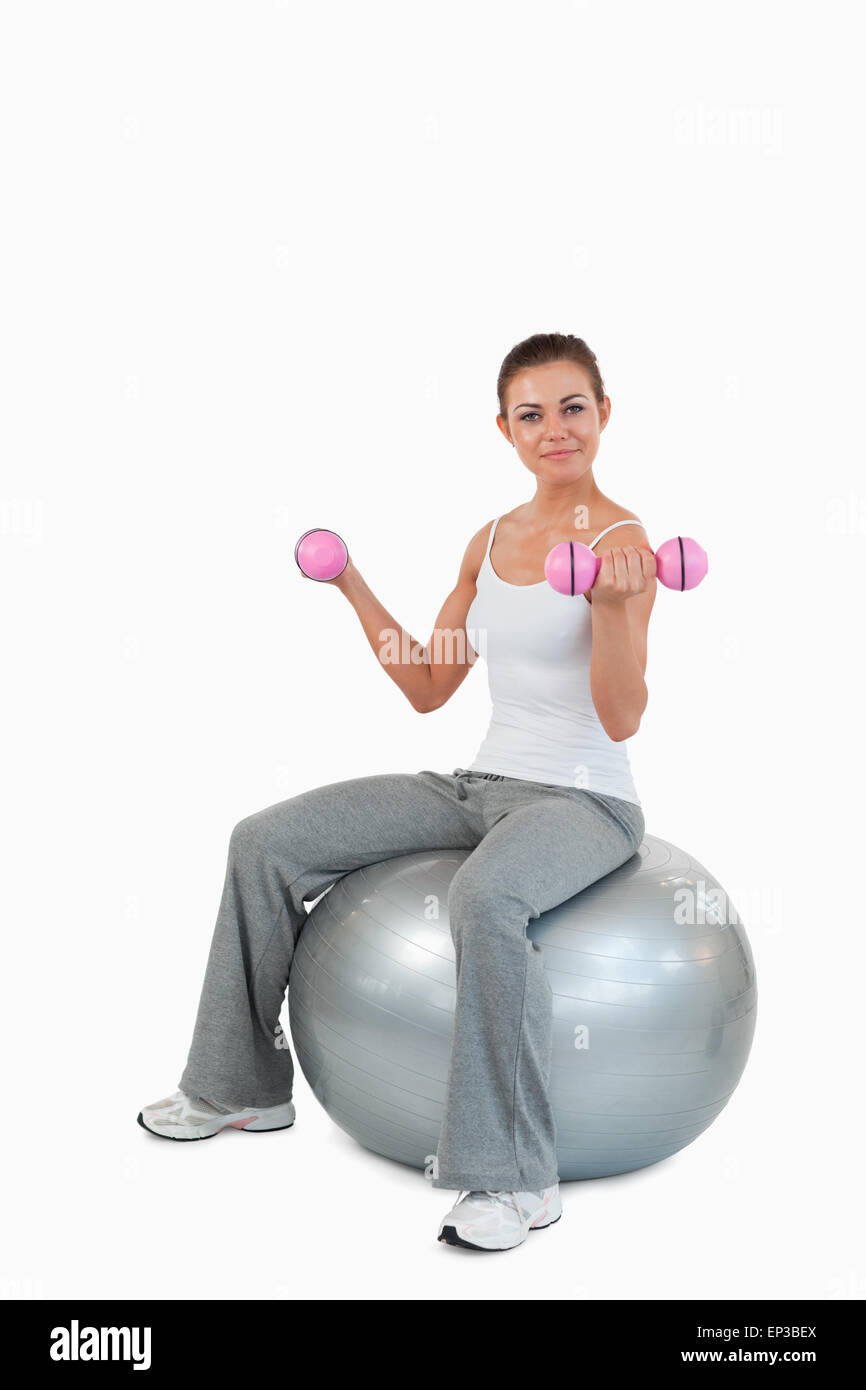 Portrait of a fit woman working out with dumbbells and a ball Stock ...