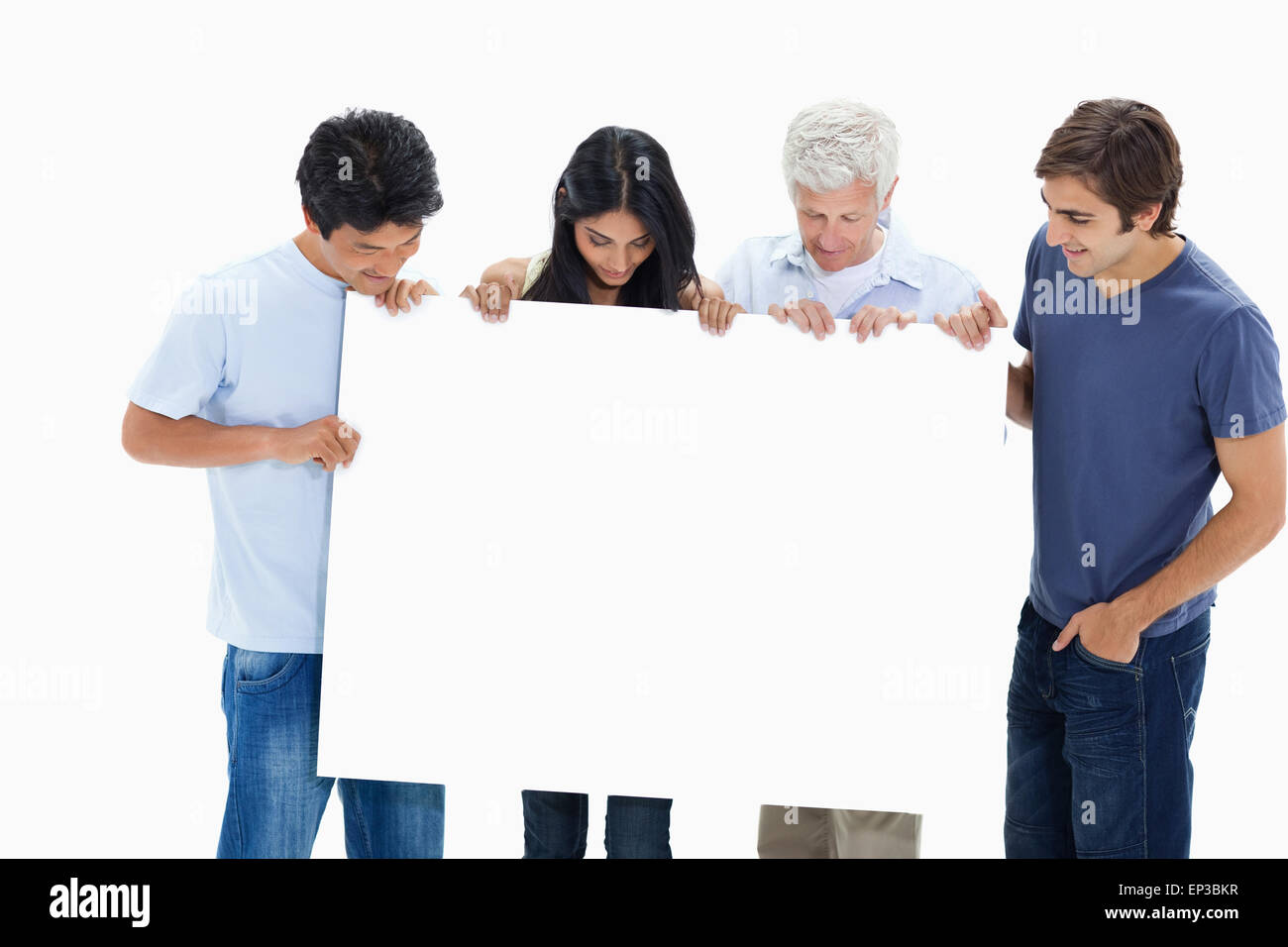 People in jeans holding and watching a big sign Stock Photo - Alamy