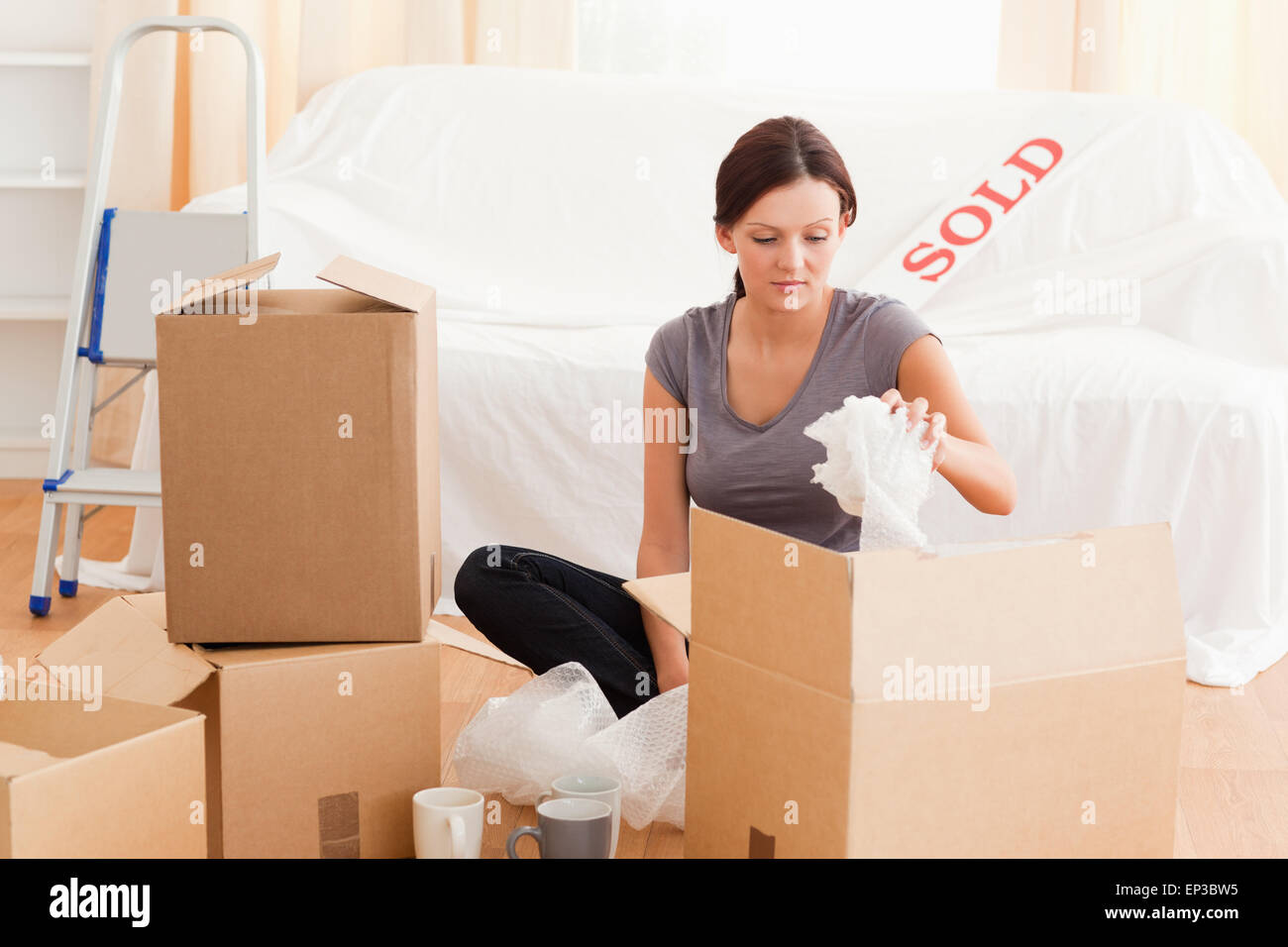 Gorgeous woman packing her property Stock Photo - Alamy