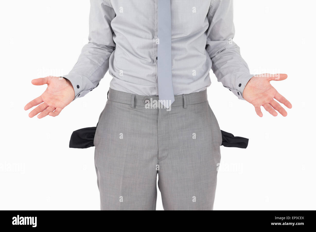 Broke businessman with empty pockets Stock Photo - Alamy