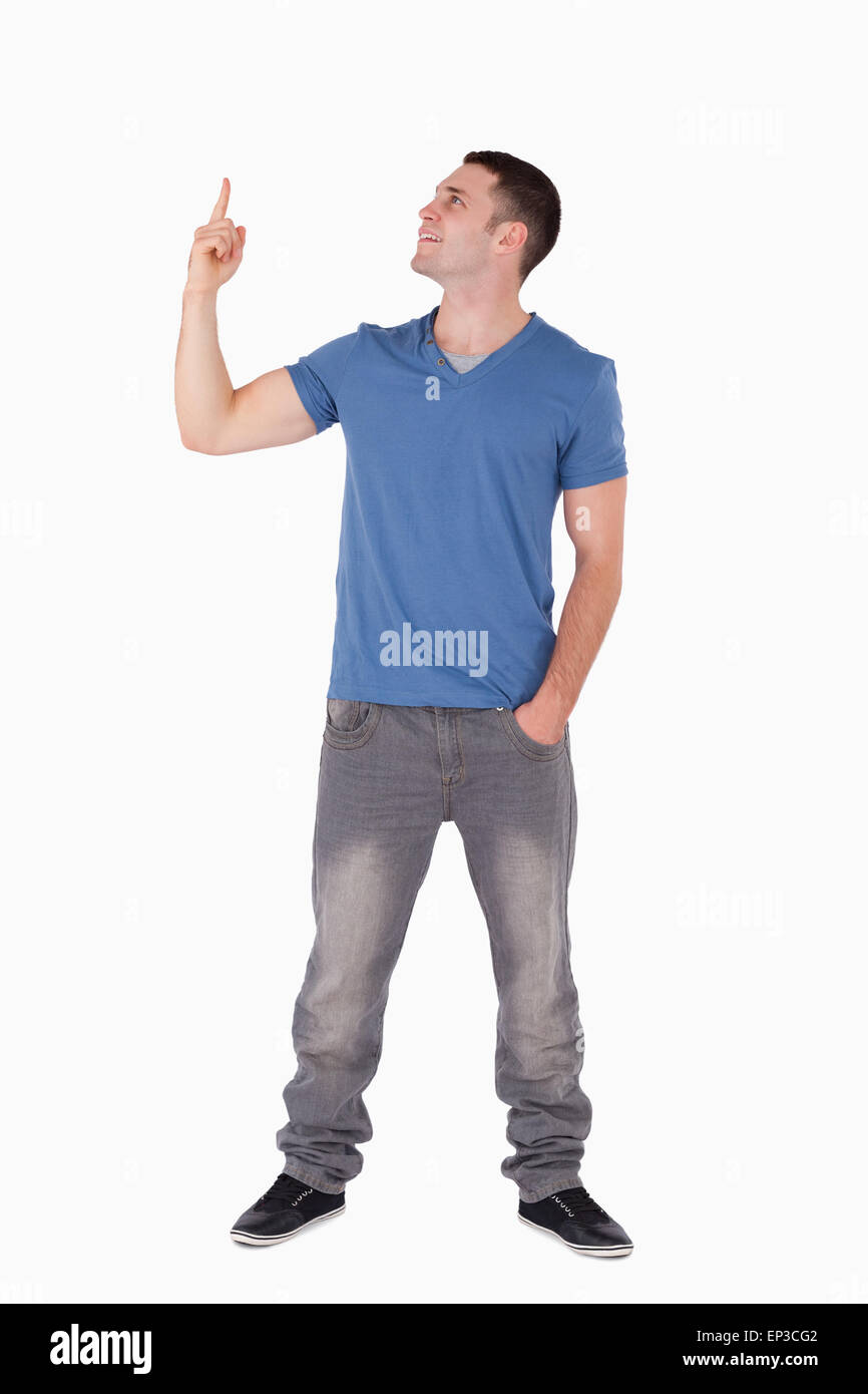 Portrait of a young man pointing at something Stock Photo - Alamy