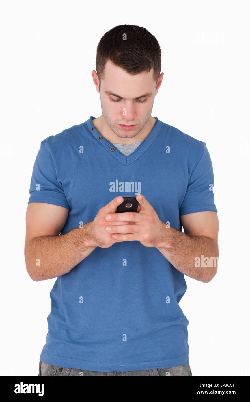 Portrait of a smiling man sending text messages Stock Photo - Alamy