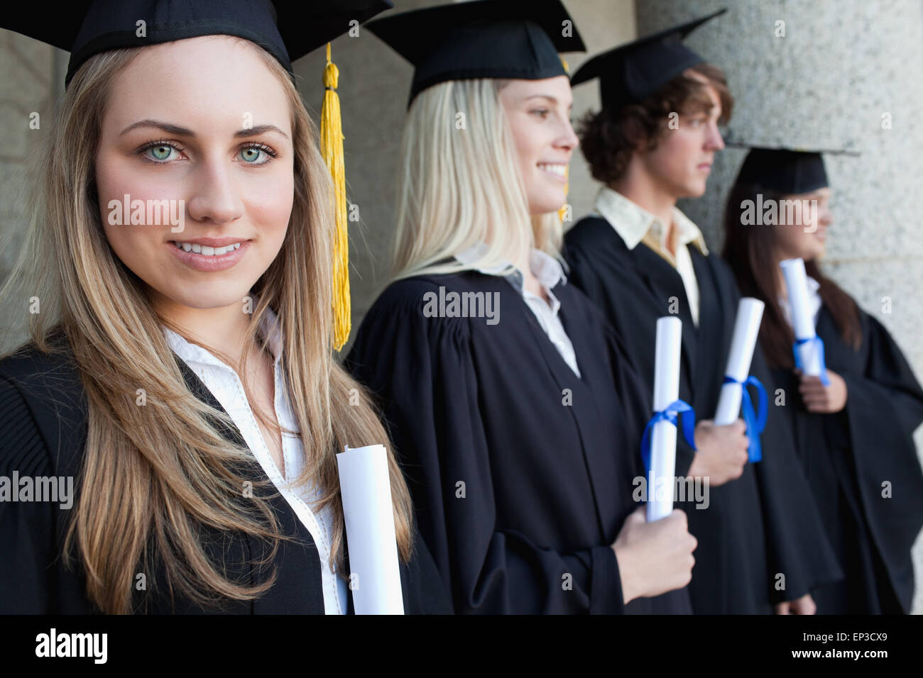 Close-up of a blonde graduate with blue eyes Stock Photo - Alamy
