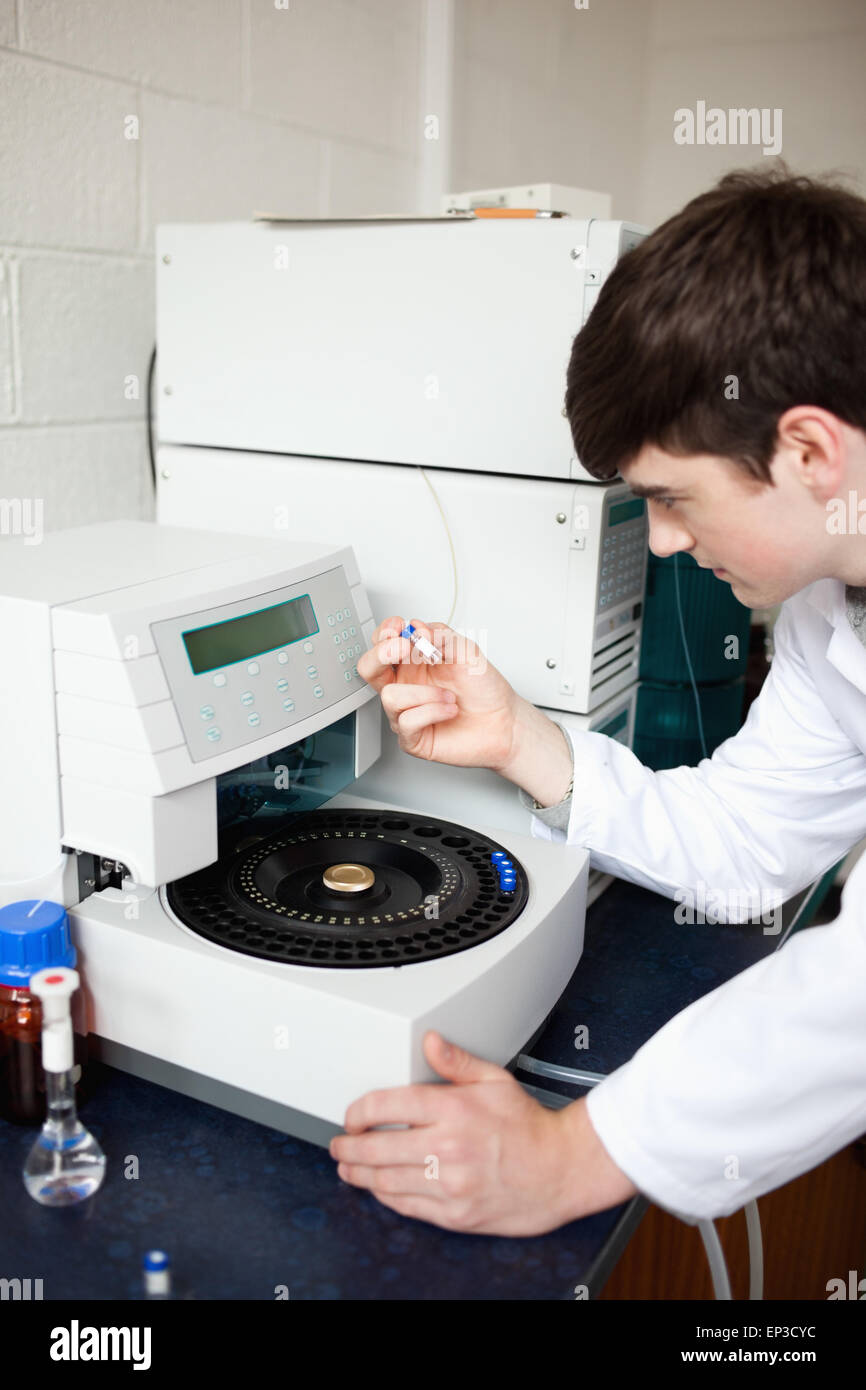 Male laboratory assistant using a centrifuge Stock Photo - Alamy