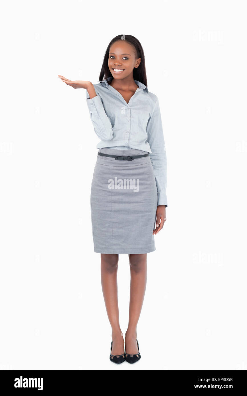 Portrait of a smiling businesswoman displaying something Stock Photo ...