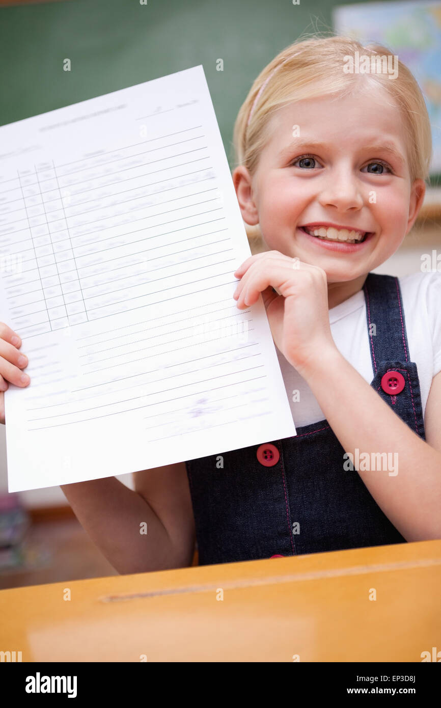 Portrait of a girl showing her school report Stock Photo - Alamy