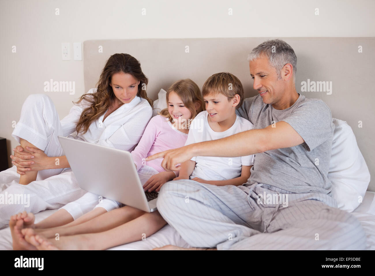 Family using a laptop Stock Photo - Alamy