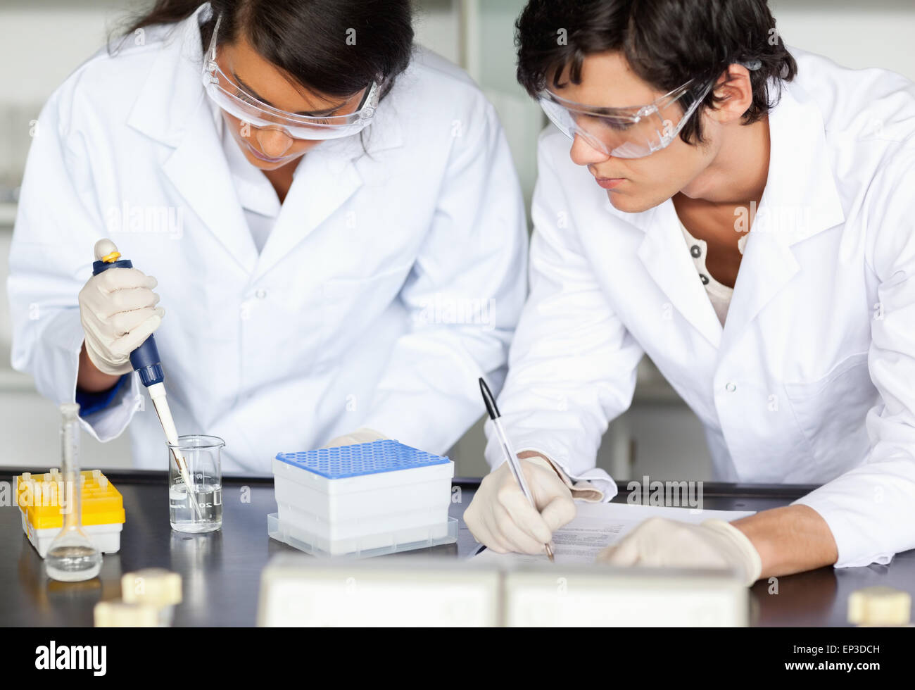 Scientists making an experiment Stock Photo - Alamy