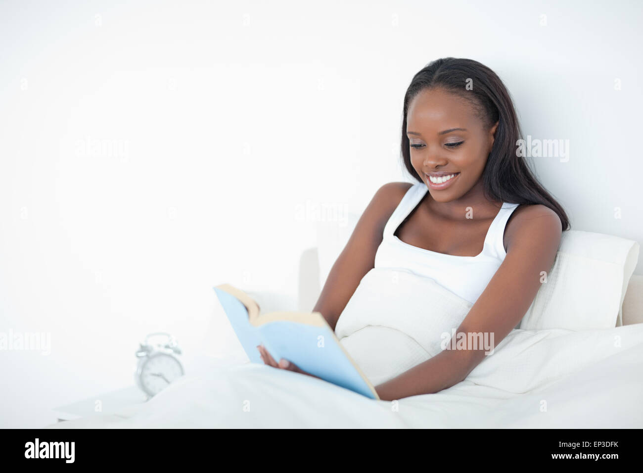 Happy woman reading a book Stock Photo - Alamy