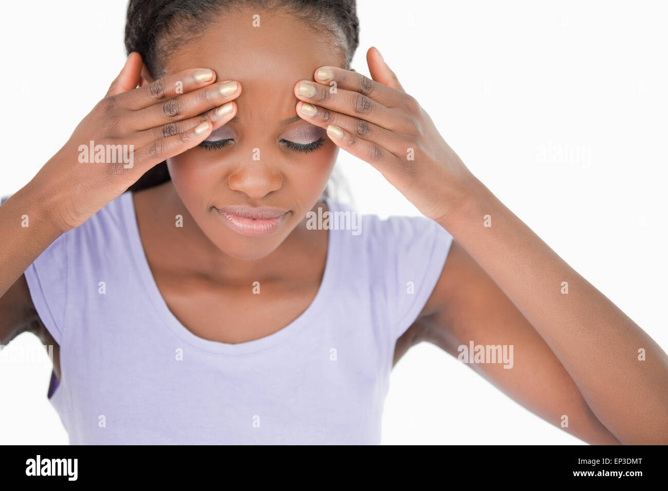 Close up of woman rubbing her temples against a white background Stock ...