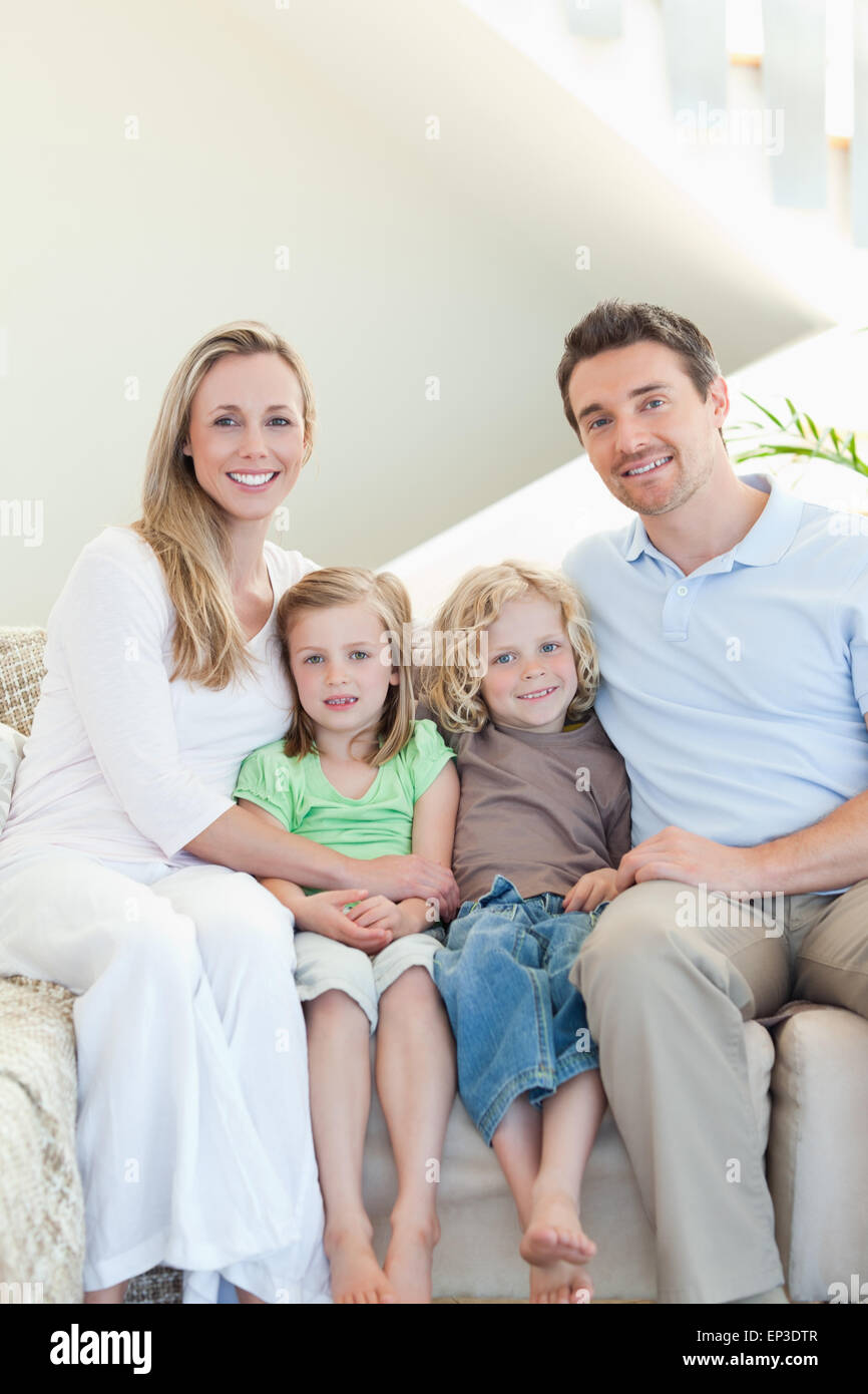 Family sitting on the couch Stock Photo - Alamy