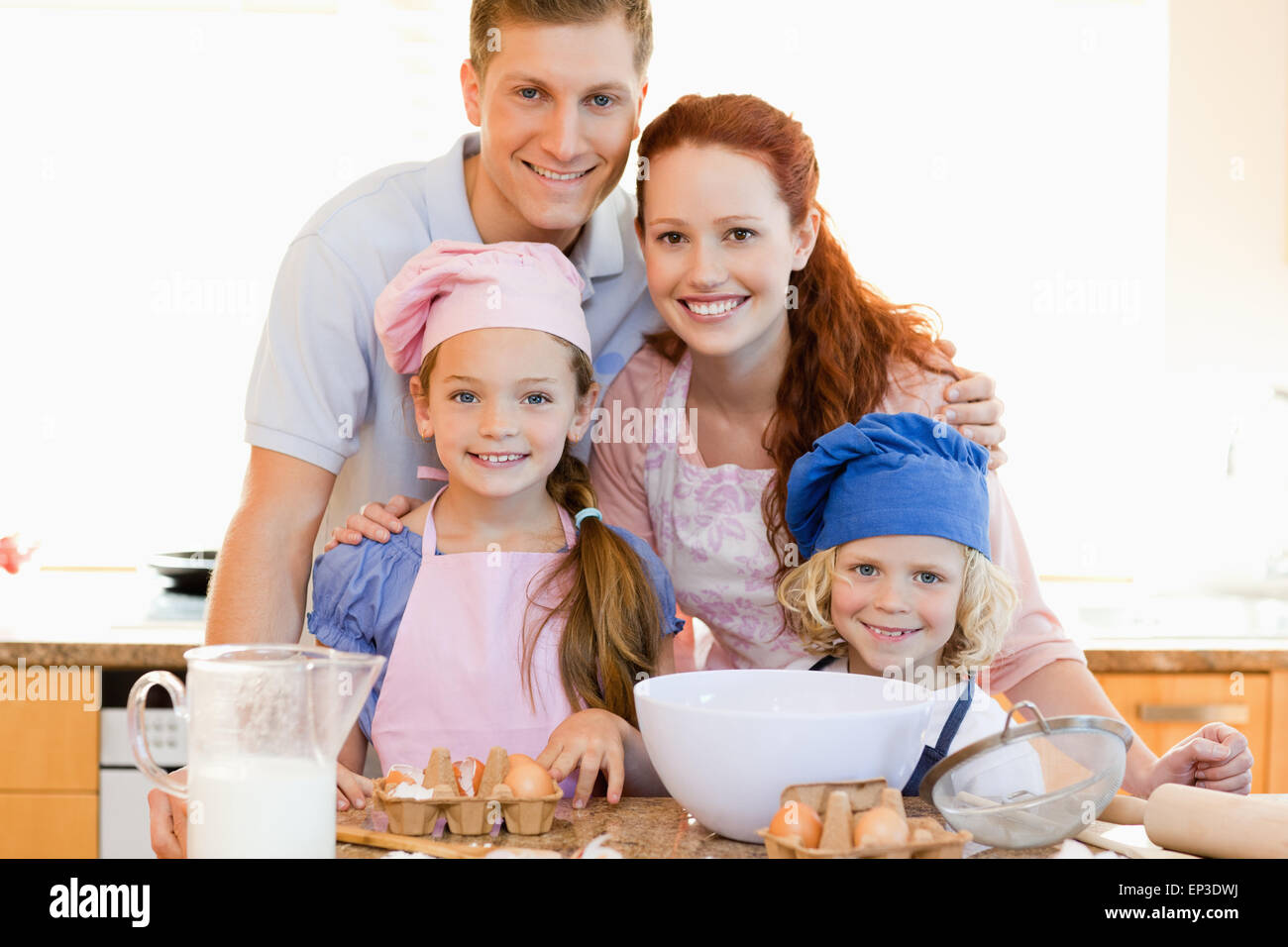 Family with baking ingredients in the kitchen Stock Photo - Alamy