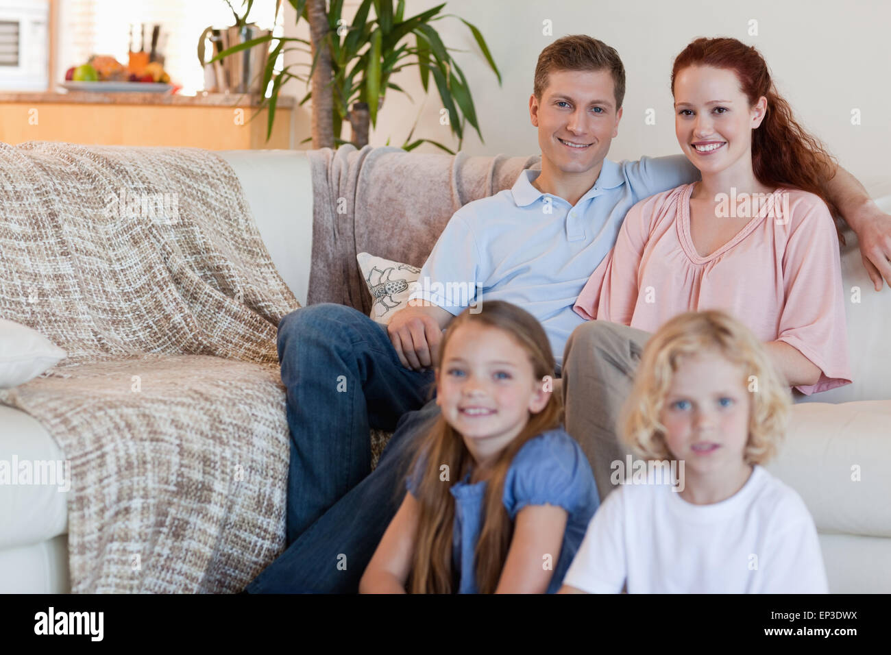 Family sitting in the living room Stock Photo - Alamy