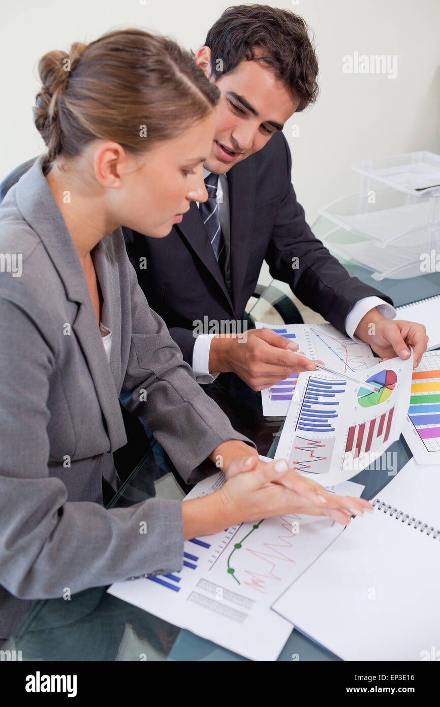 Portrait of a young business team studying statistics Stock Photo - Alamy