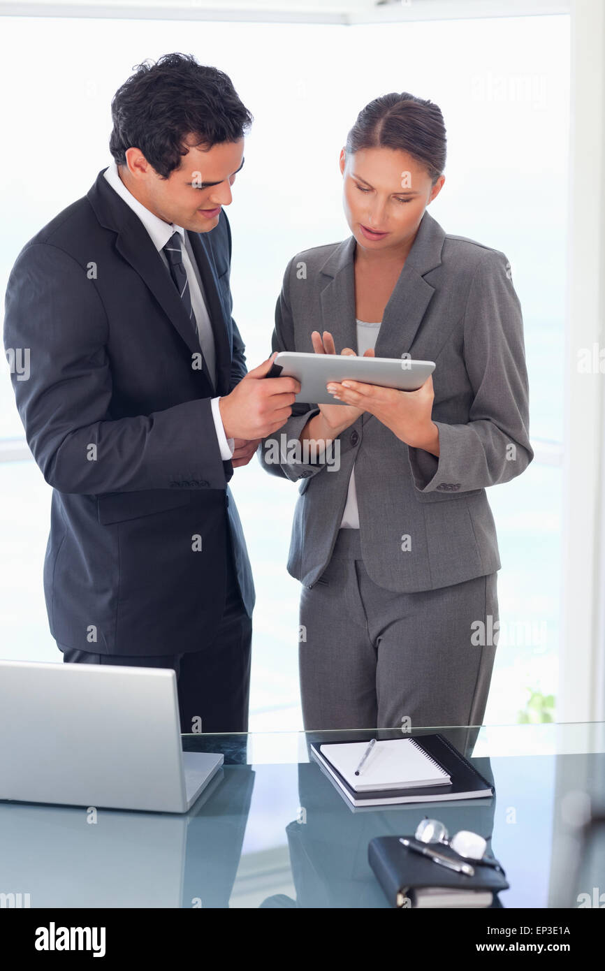 Tradesman explaining functionality of tablet to his colleague Stock ...