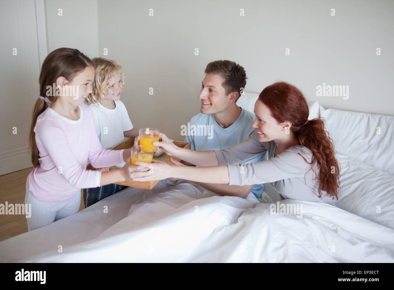 Children surprising their parents with breakfast Stock Photo - Alamy
