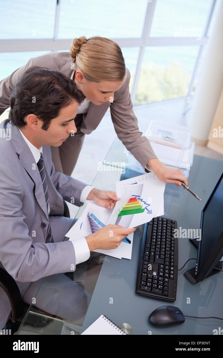 Portrait of a focused business team looking at a graph Stock Photo - Alamy