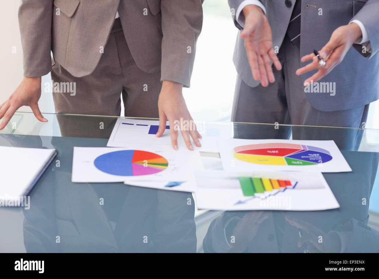 Hands of business people working on statistics Stock Photo - Alamy
