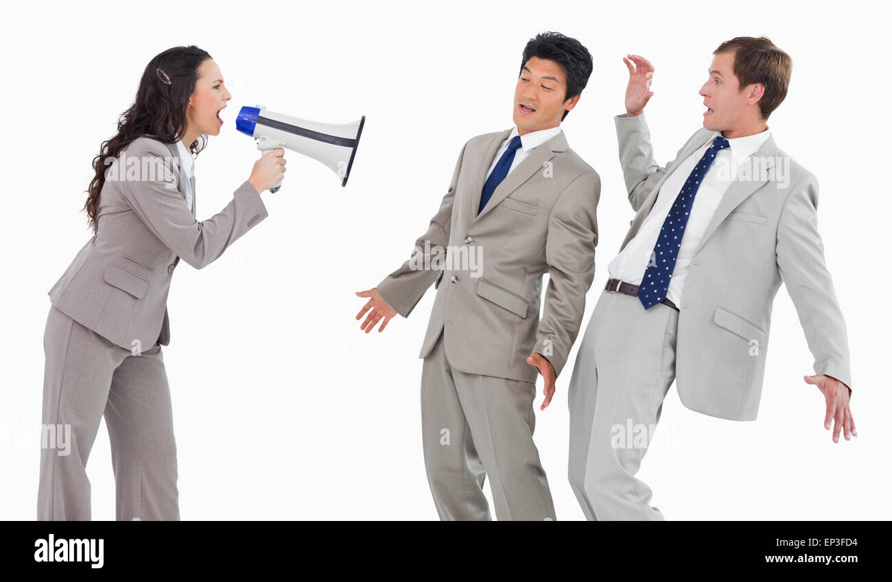 Businesswoman with megaphone shouting at colleagues Stock Photo - Alamy