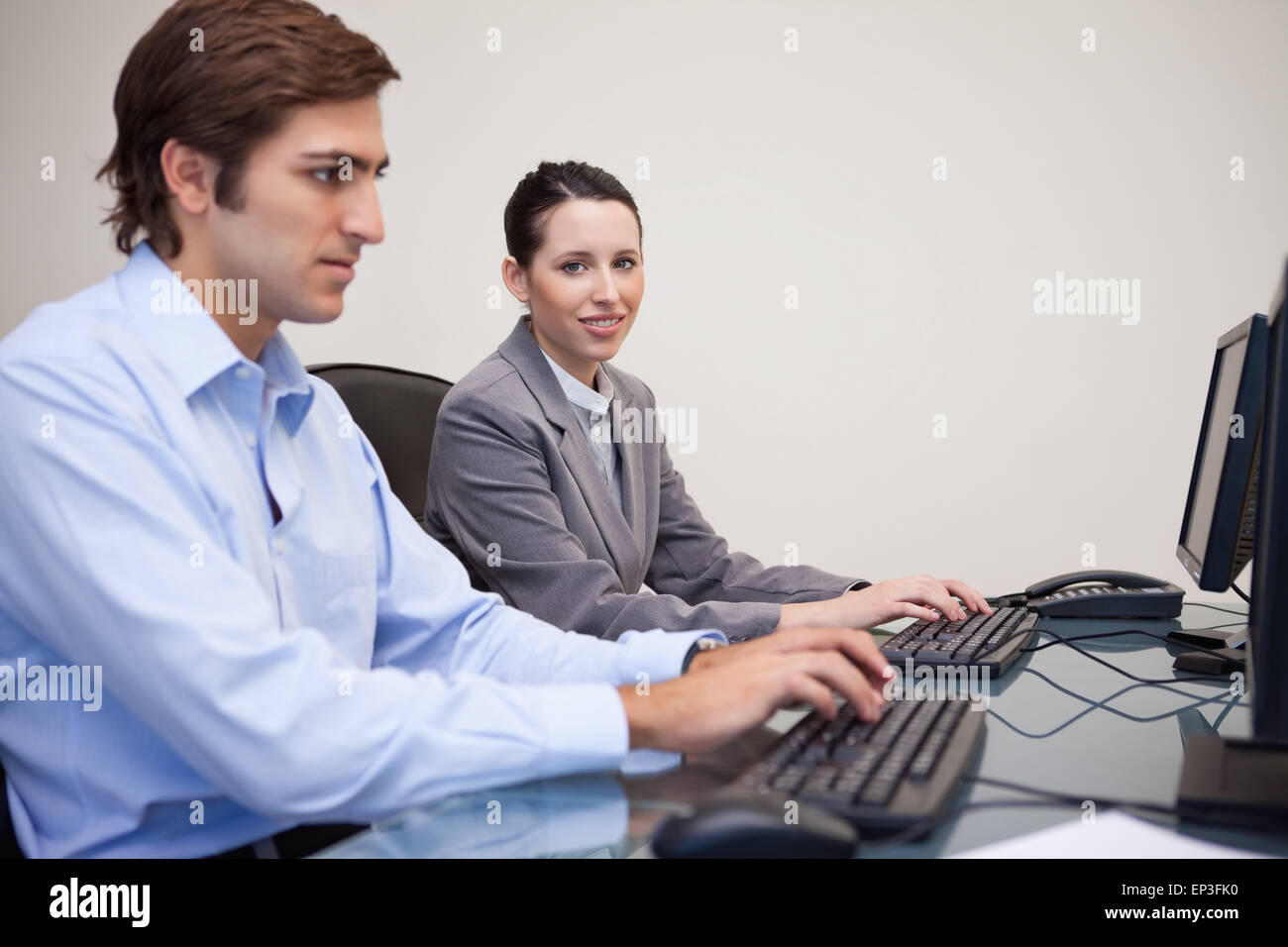 Side view of business team working in their office Stock Photo - Alamy