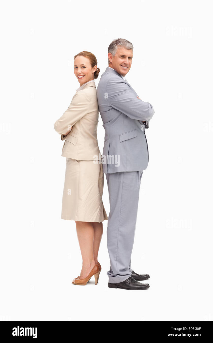 Portrait of smiling business people back to back Stock Photo - Alamy