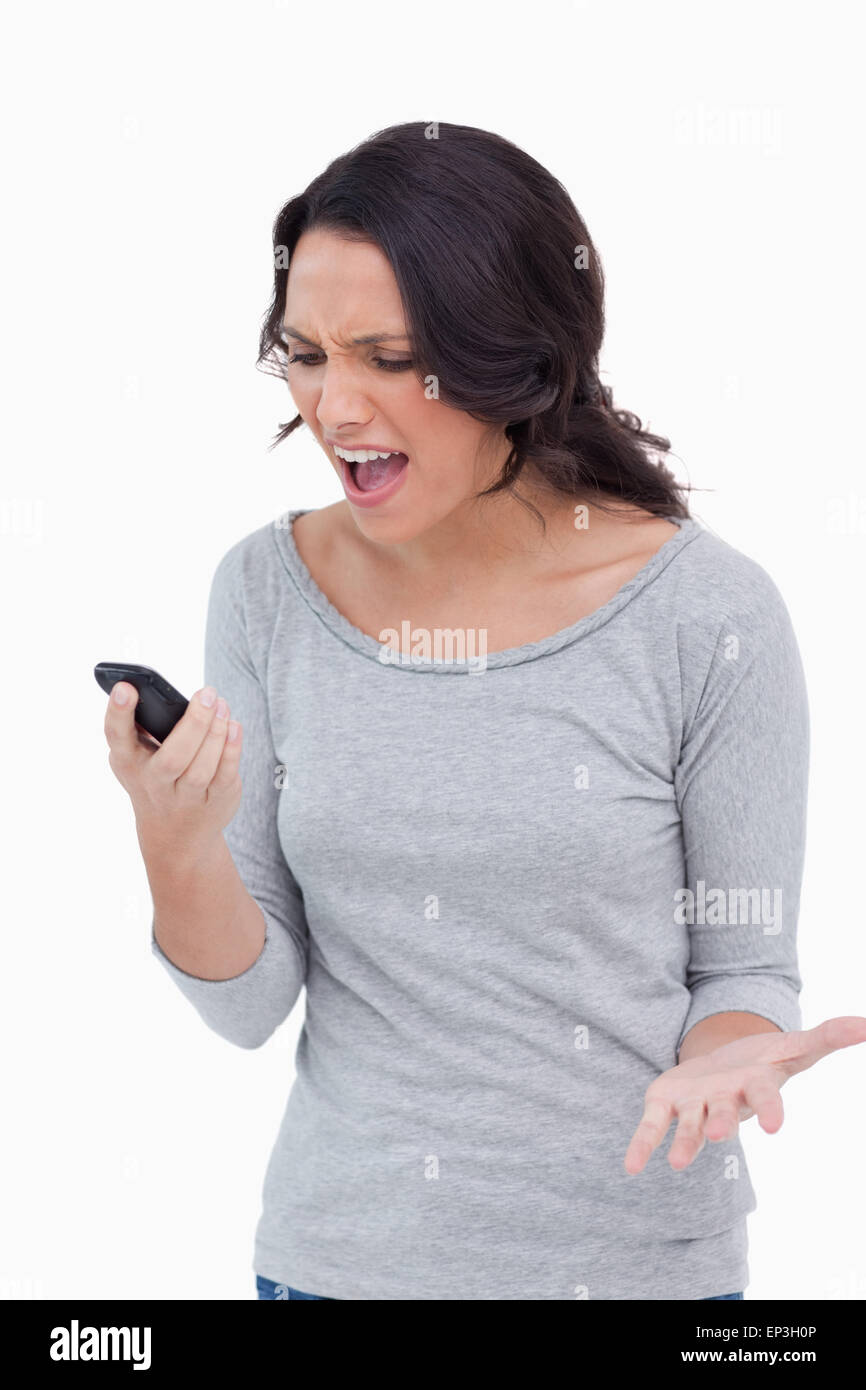 Close up of woman yelling into her mobile phone Stock Photo - Alamy