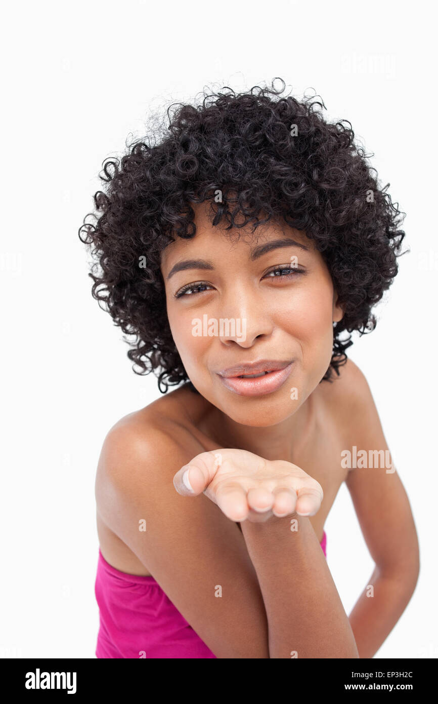 Smiling woman sending a kiss in front of the camera Stock Photo - Alamy
