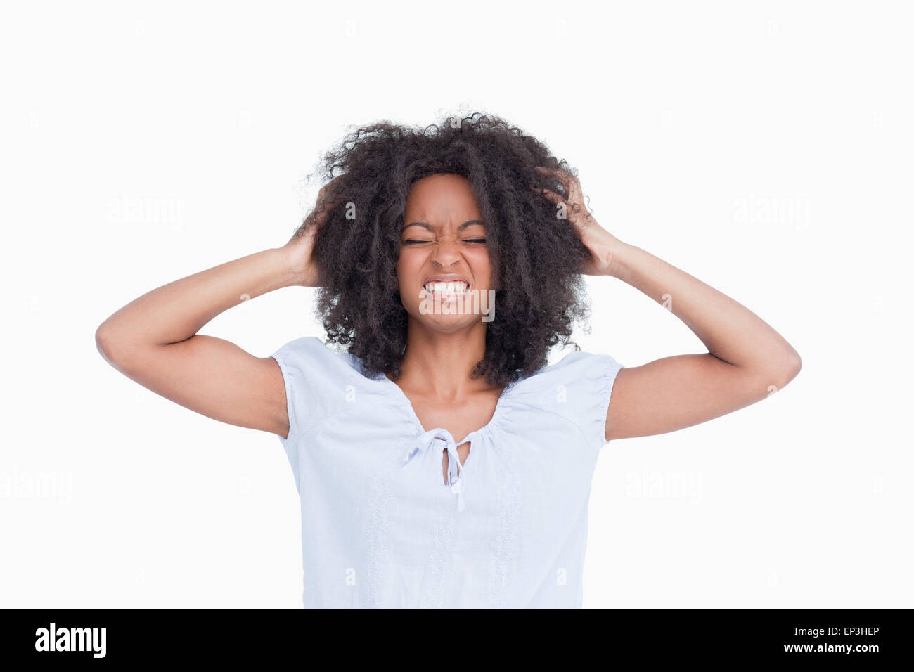 Young woman showing her anger by holding her head Stock Photo - Alamy