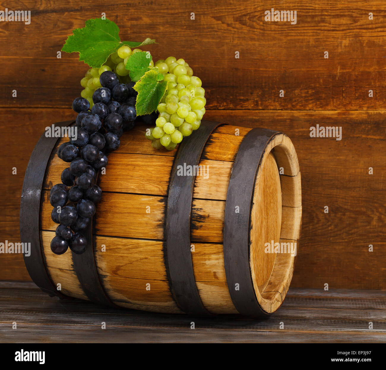Still life with barrel decorated red and white grapes Stock Photo - Alamy