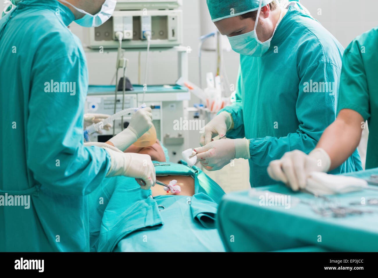Surgeon operating a patient in an operating theater Stock Photo - Alamy