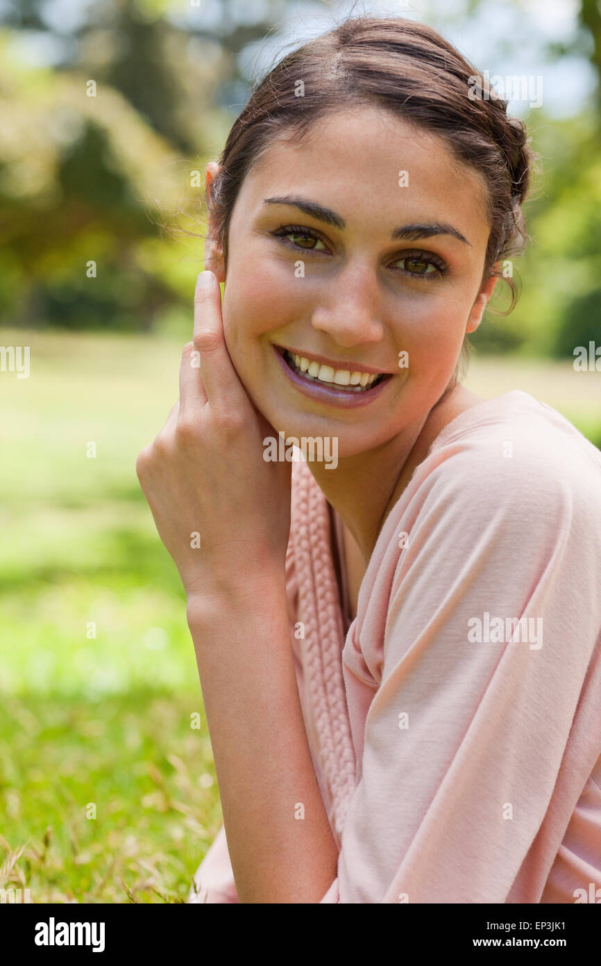 Woman resting her head against her arms while lying on her front Stock ...