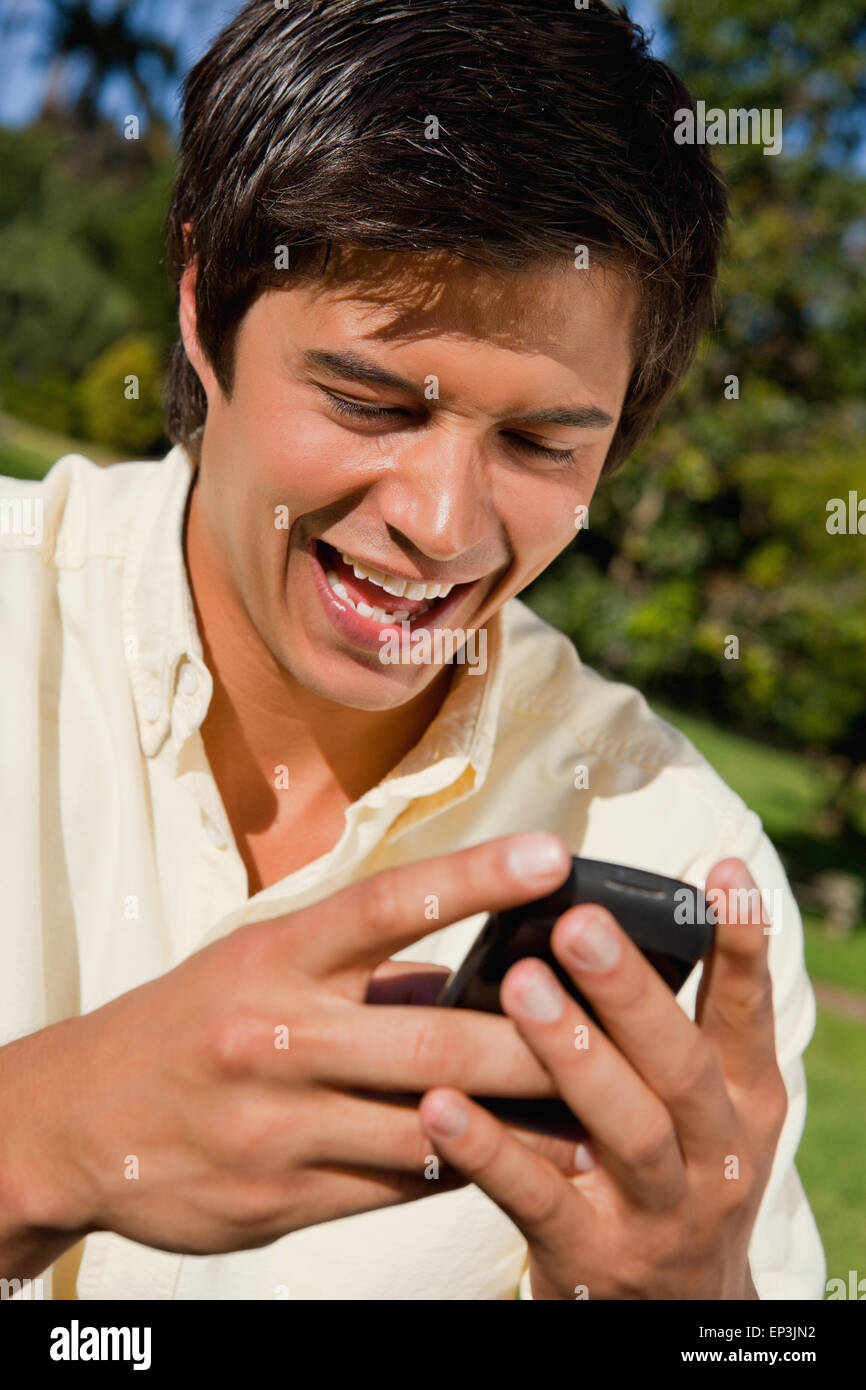Close-up of a man using a phone while he is sitting down Stock Photo ...