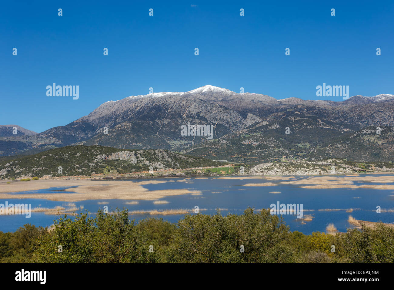 Stymfalia lake in Corinthia prefecture, Greece with the snowy mountains ...