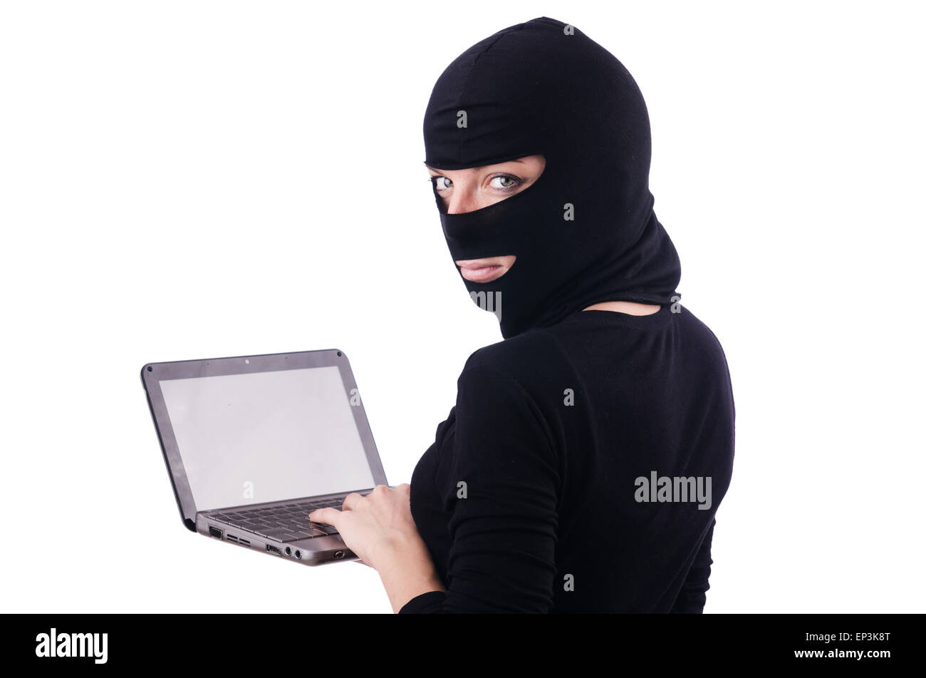 Hacker with computer wearing balaclava Stock Photo - Alamy