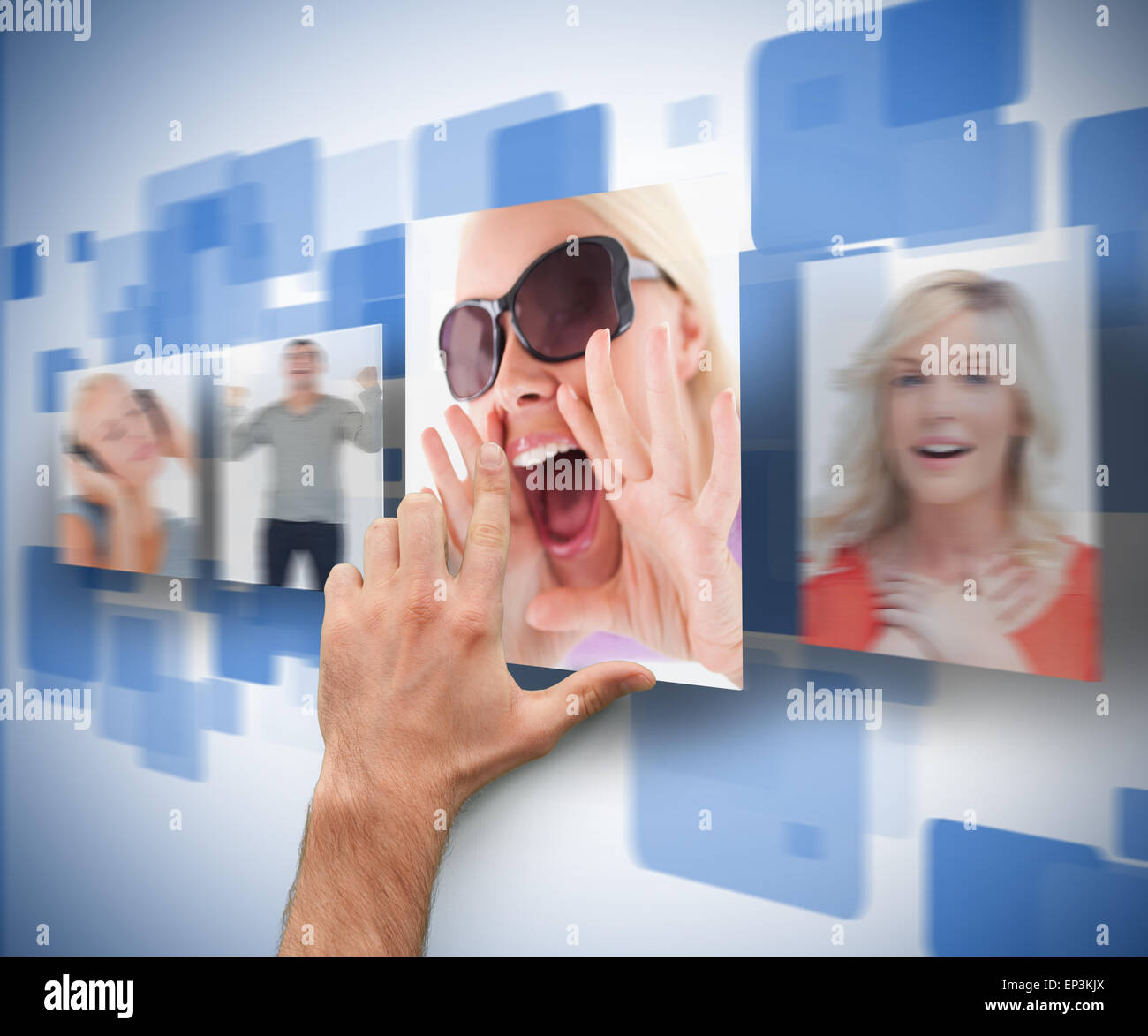 Male hand selecting picture from digital wall Stock Photo - Alamy