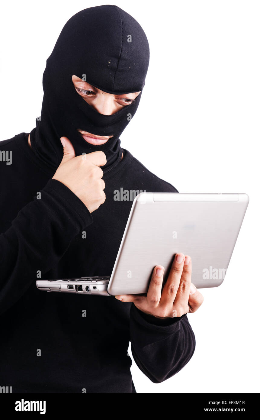 Hacker with computer wearing balaclava Stock Photo - Alamy