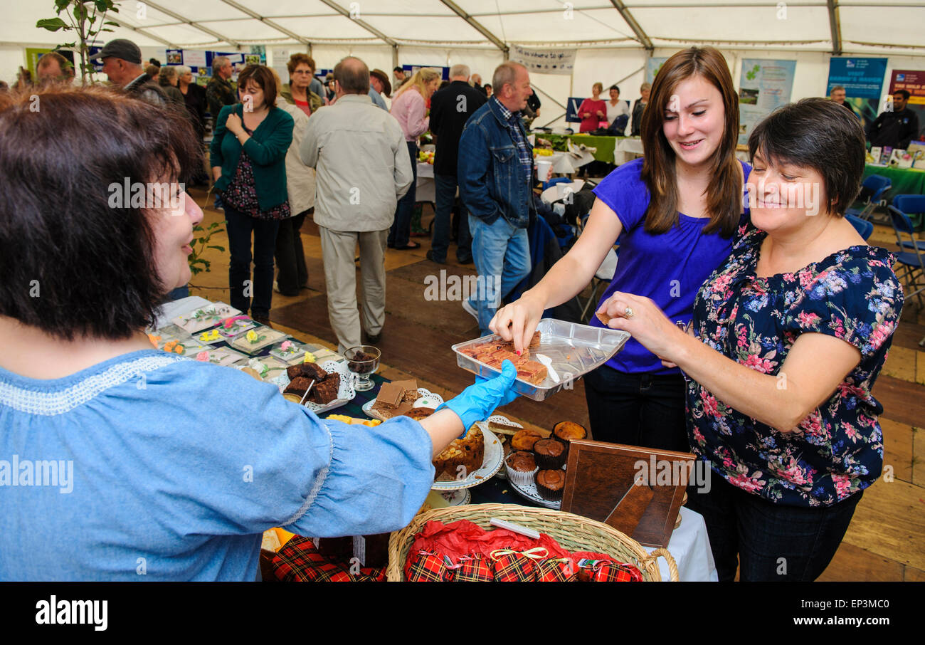 Two woman try a free sample at a Farmers Market Stock Photo - Alamy
