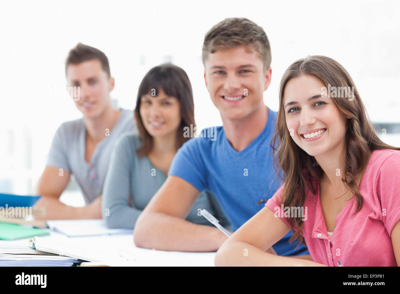Side view of four students turned and looking towards the camera Stock ...