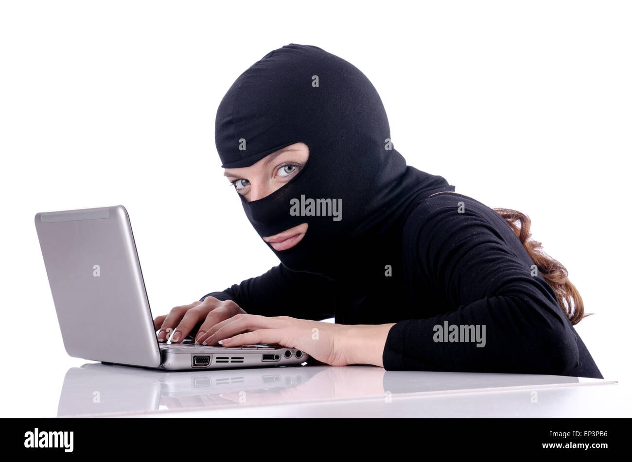 Hacker with computer wearing balaclava Stock Photo - Alamy