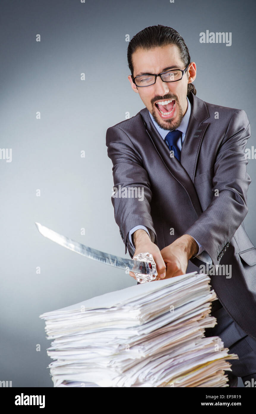 Businessman cutting the pile of paper Stock Photo - Alamy