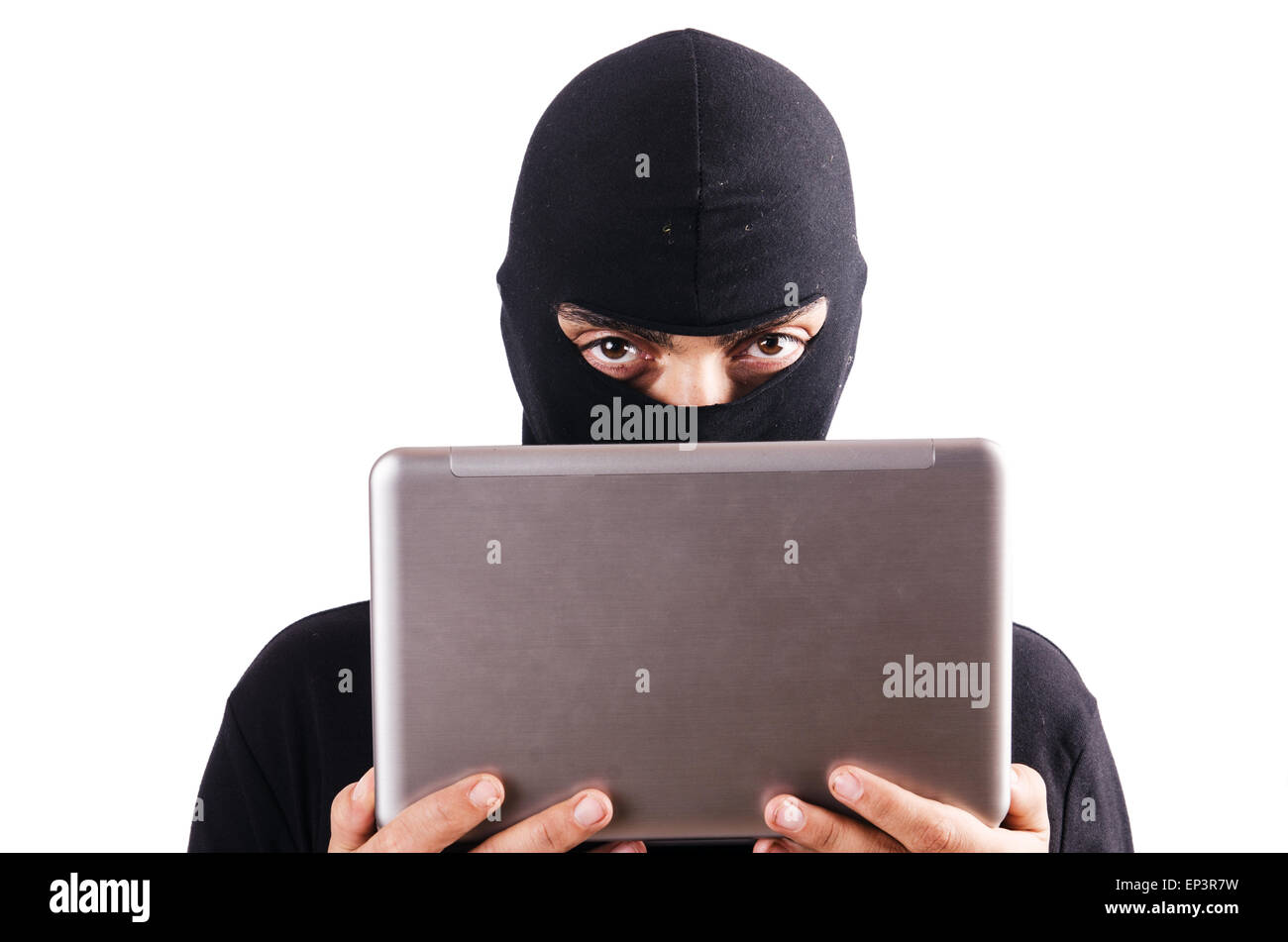 Hacker with computer wearing balaclava Stock Photo - Alamy