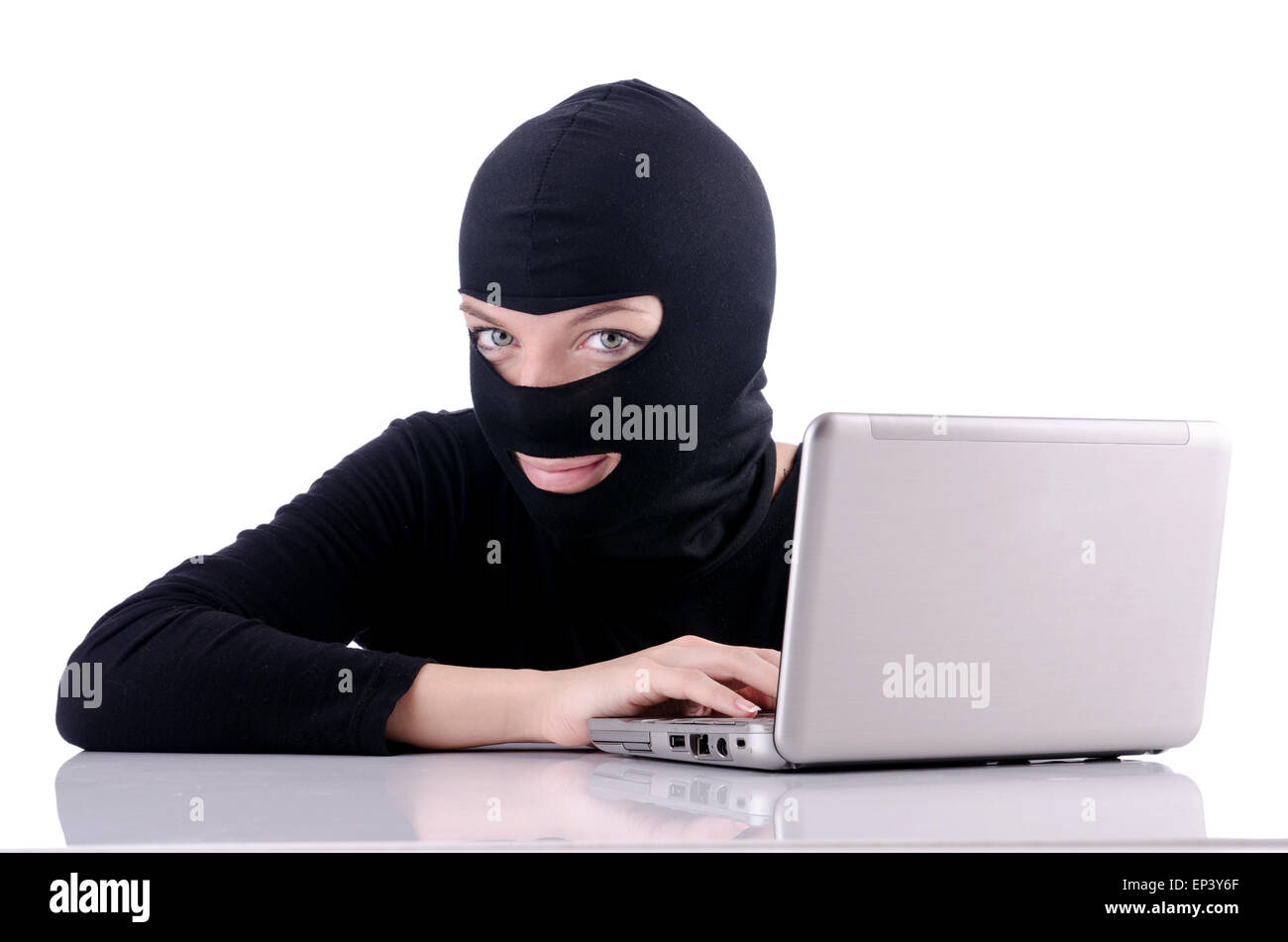 Hacker with computer wearing balaclava Stock Photo - Alamy