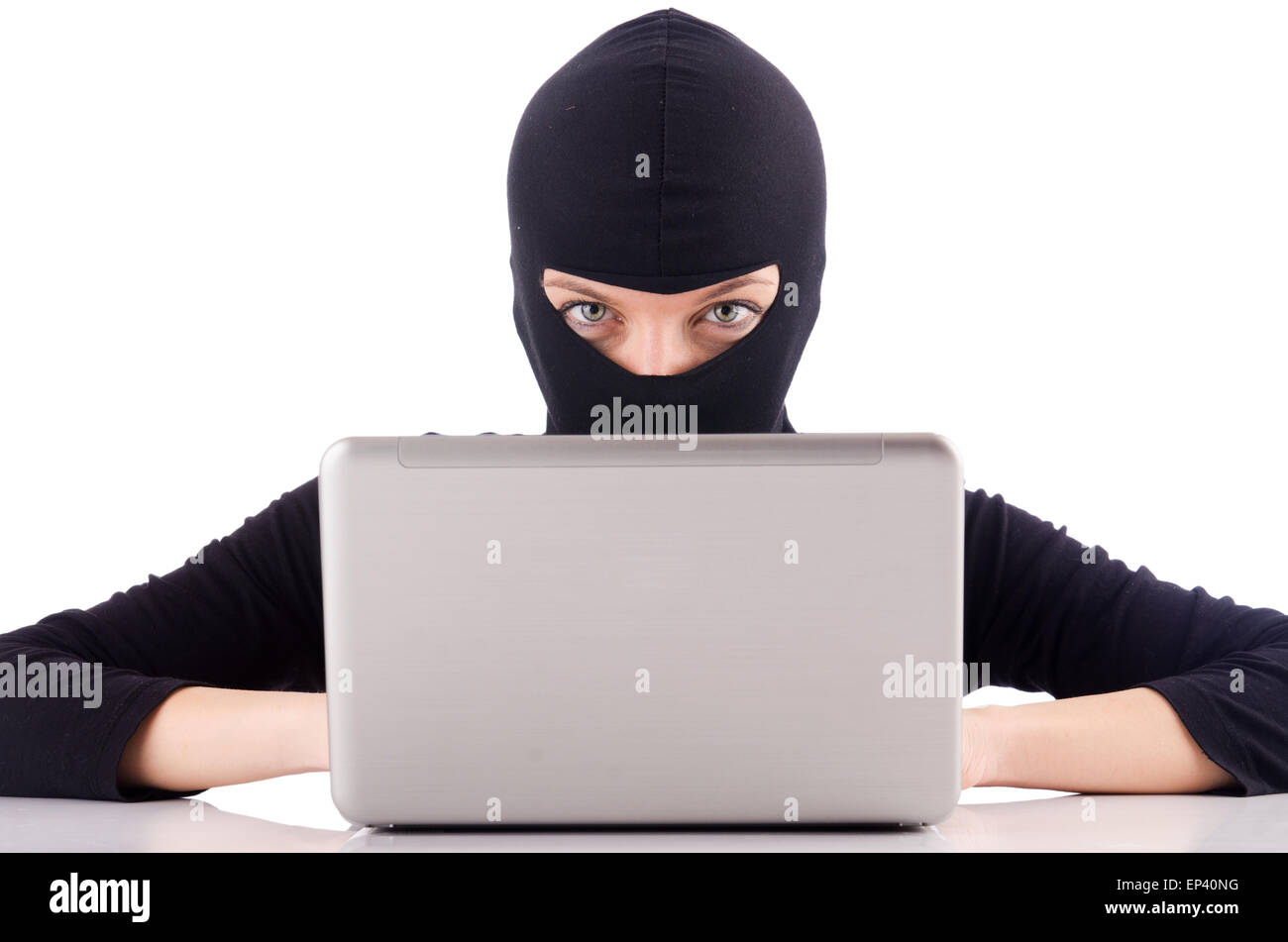 Hacker with computer wearing balaclava Stock Photo - Alamy