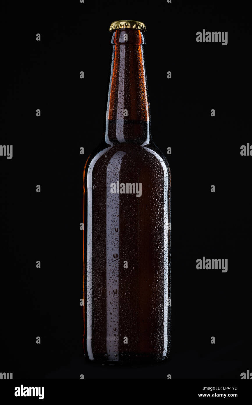 Beer bottle with water drops isolated on black Stock Photo - Alamy