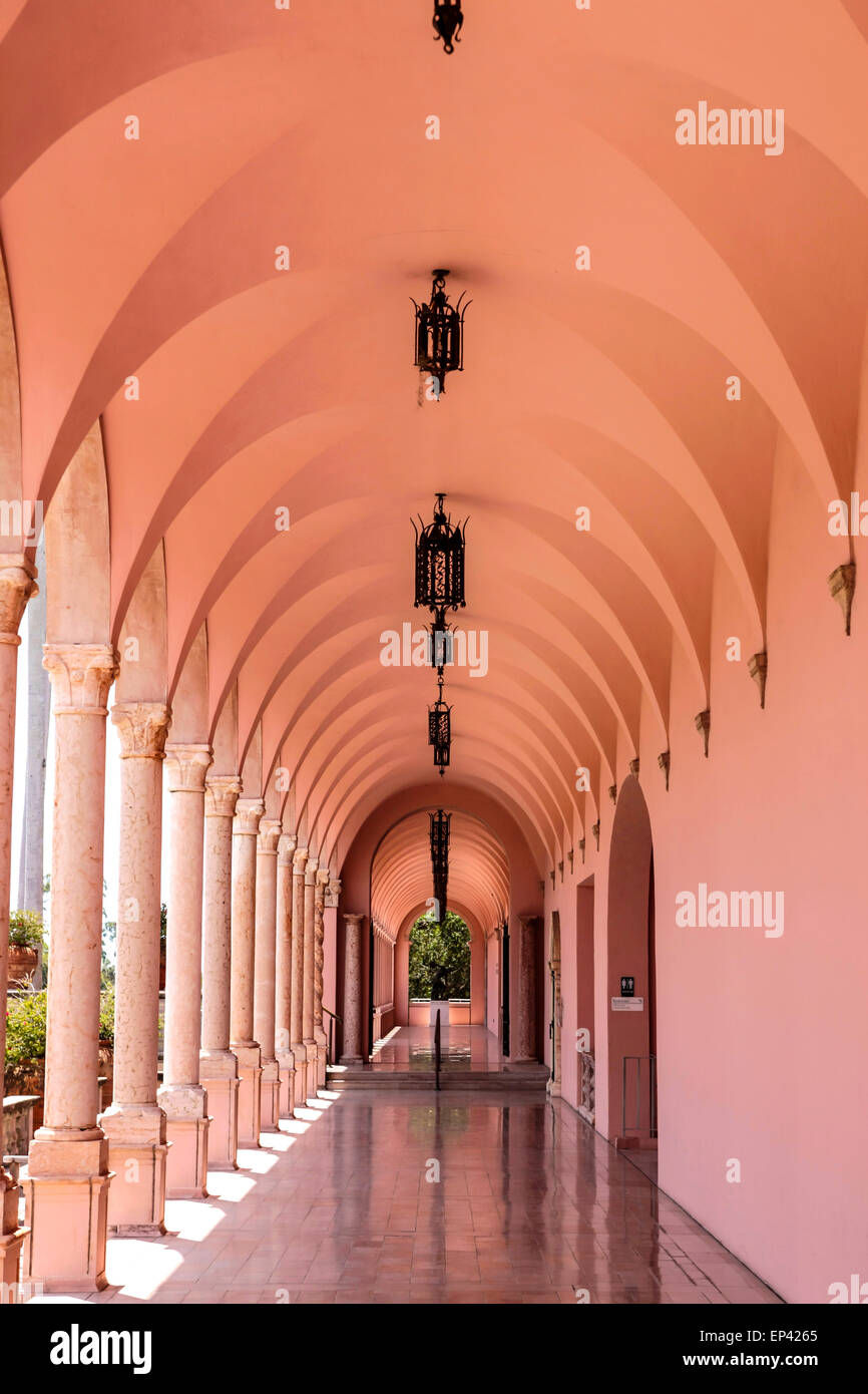 The shaded pink walled walkway with columns and marble floors in the ...
