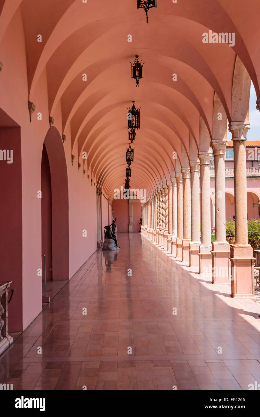 The shaded pink walled walkway with columns and marble floors in the ...