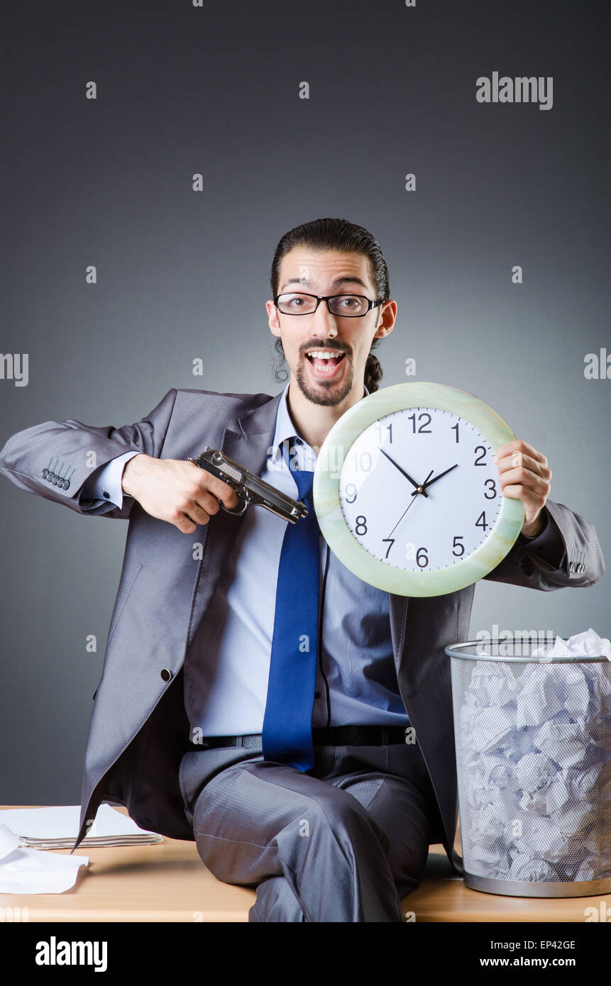 Man with clock and pile of papers Stock Photo - Alamy