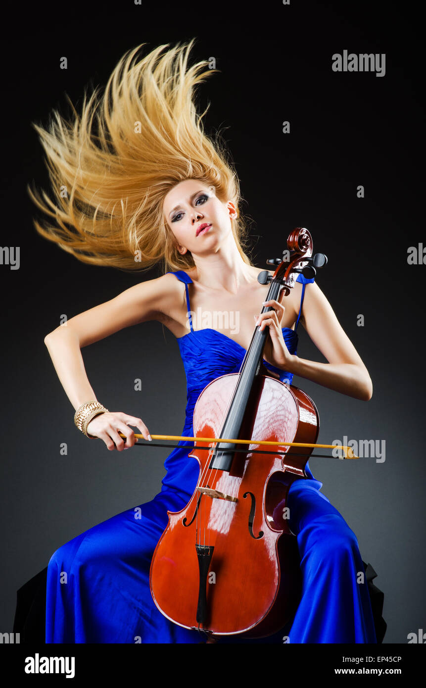 Attractive woman with cello in studio Stock Photo - Alamy