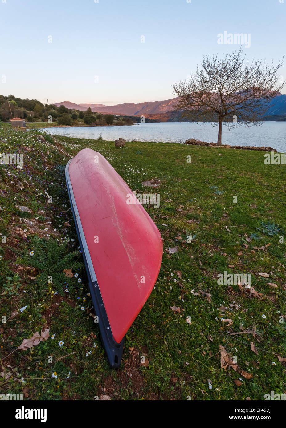 Red canoe near Ladonas lake in Greece, against a blue sky in the ...